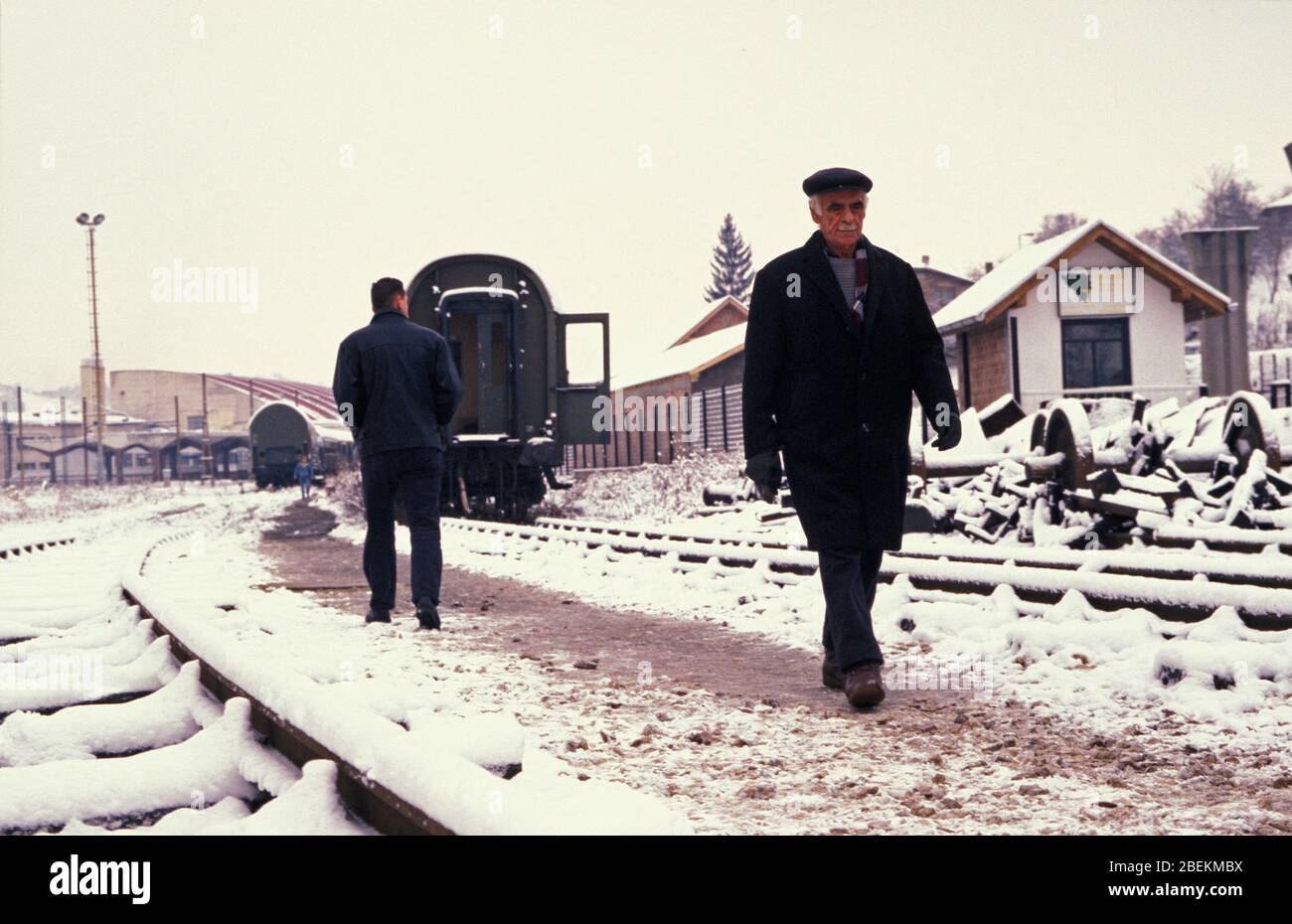 Sarajevo 1995 - people walking past war damaged trains in central ...