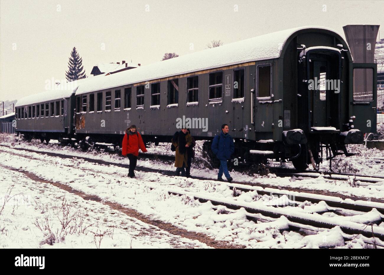 Sarajevo 1995 - people walking past war damaged trains in central ...