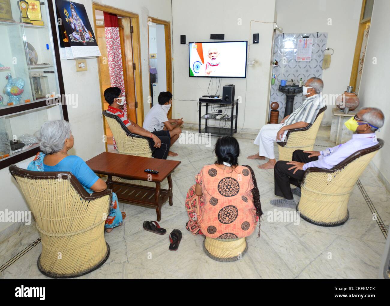 A family watches Indian Prime Minister Narendra Modi's address to the ...