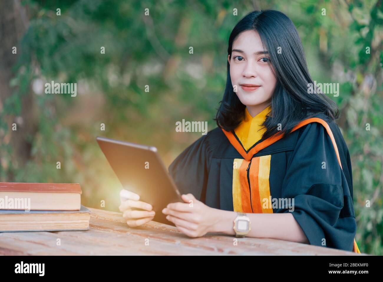 Young charming Asian female graduates celebrate her degree graduation ...