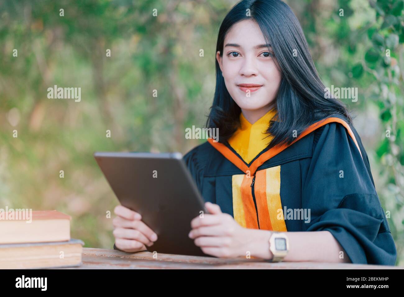 Young charming Asian female graduates celebrate her degree graduation ...