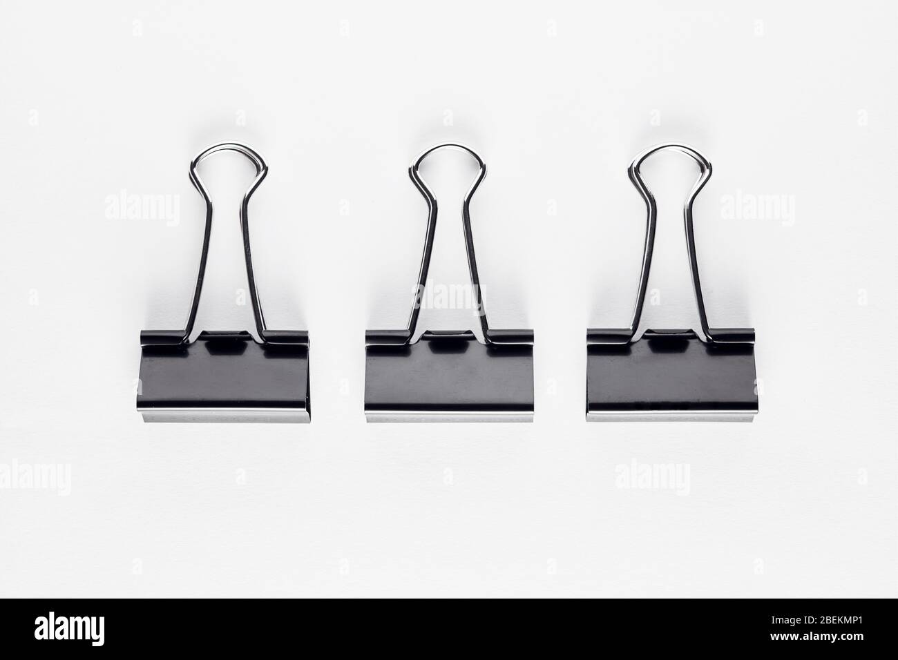Three black binder clip on white background. Close up view Stock Photo ...