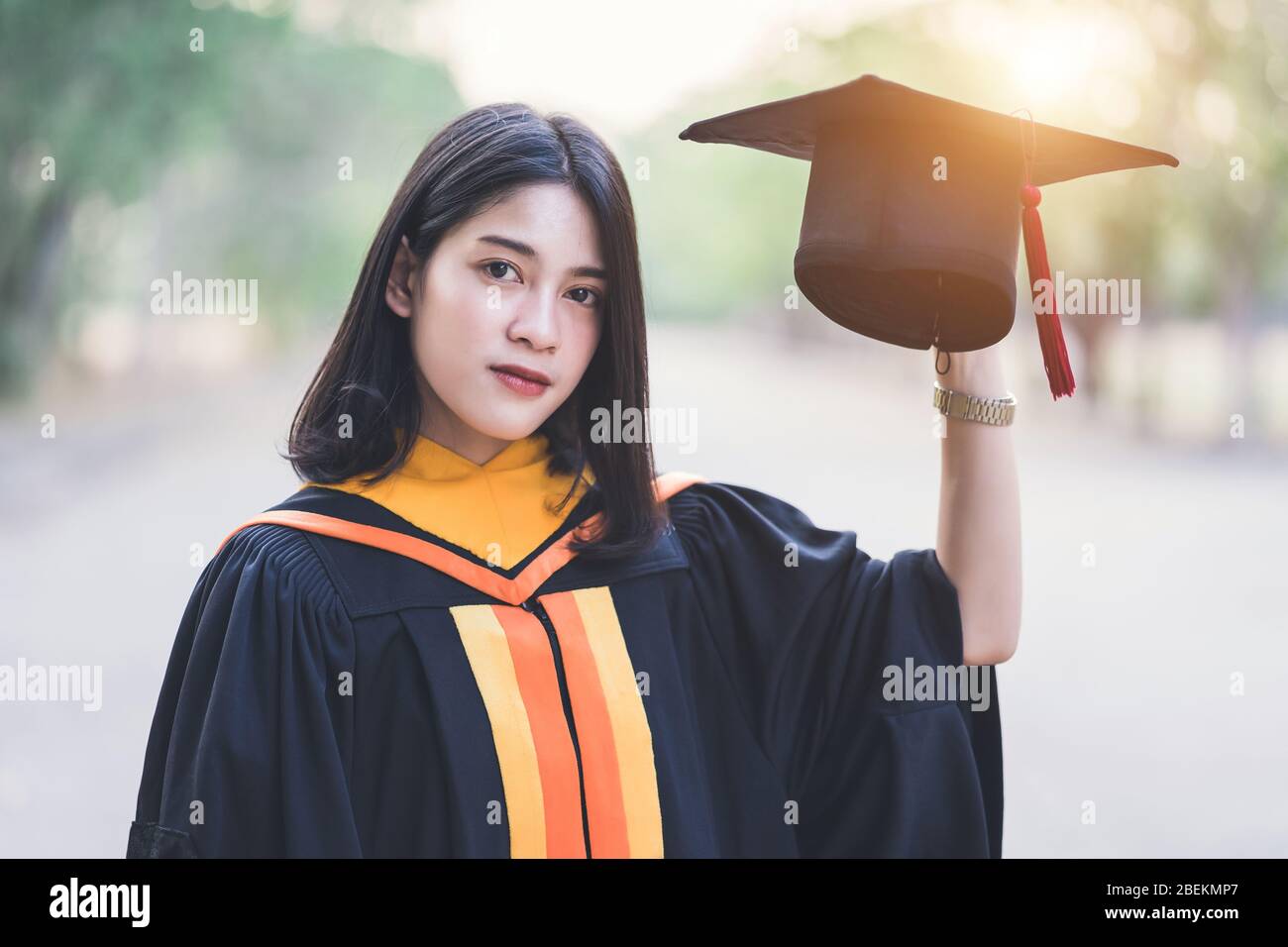 Young charming Asian female graduates celebrate her degree graduation ...