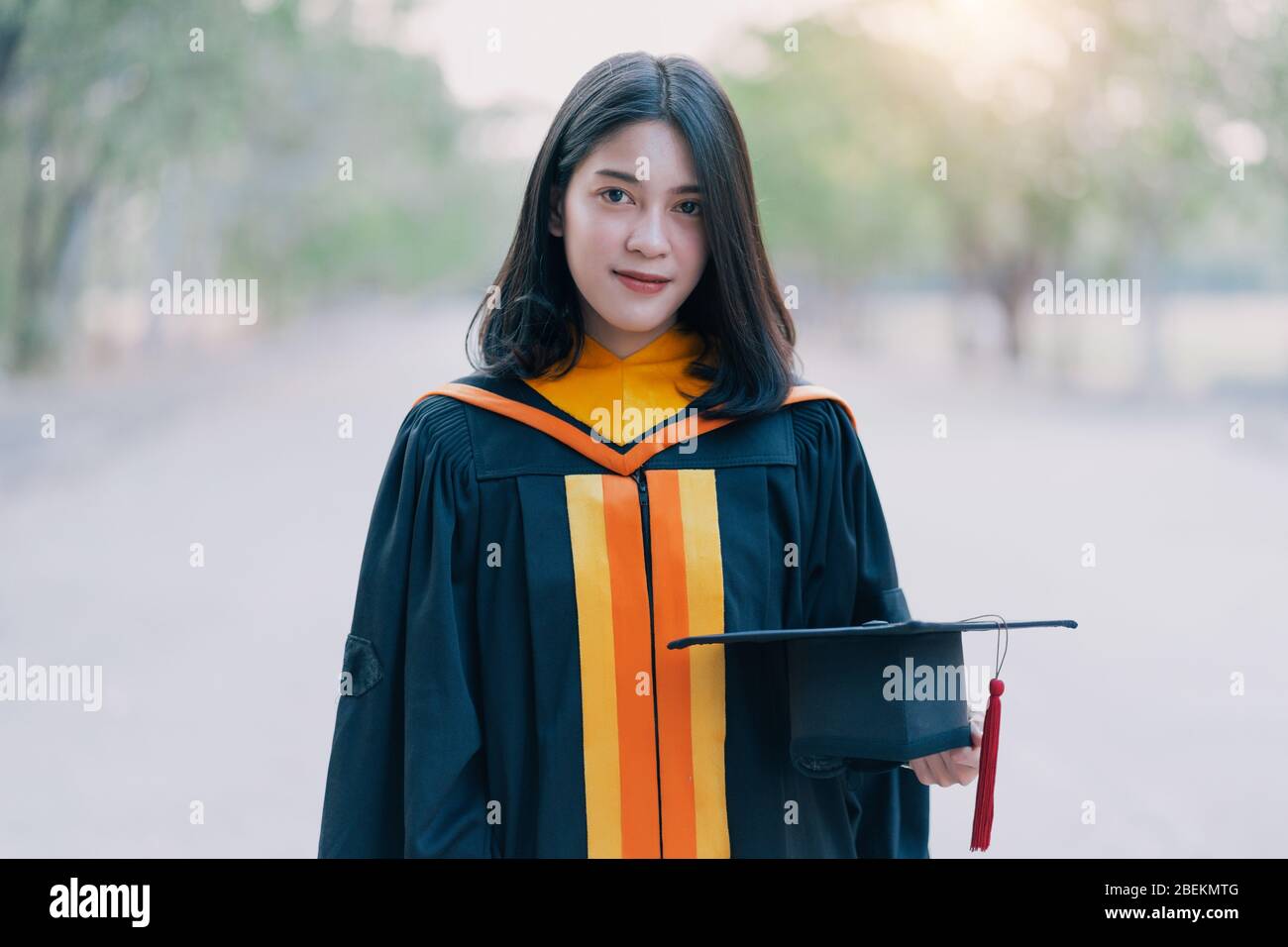 Young charming Asian female graduates celebrate her degree graduation ...