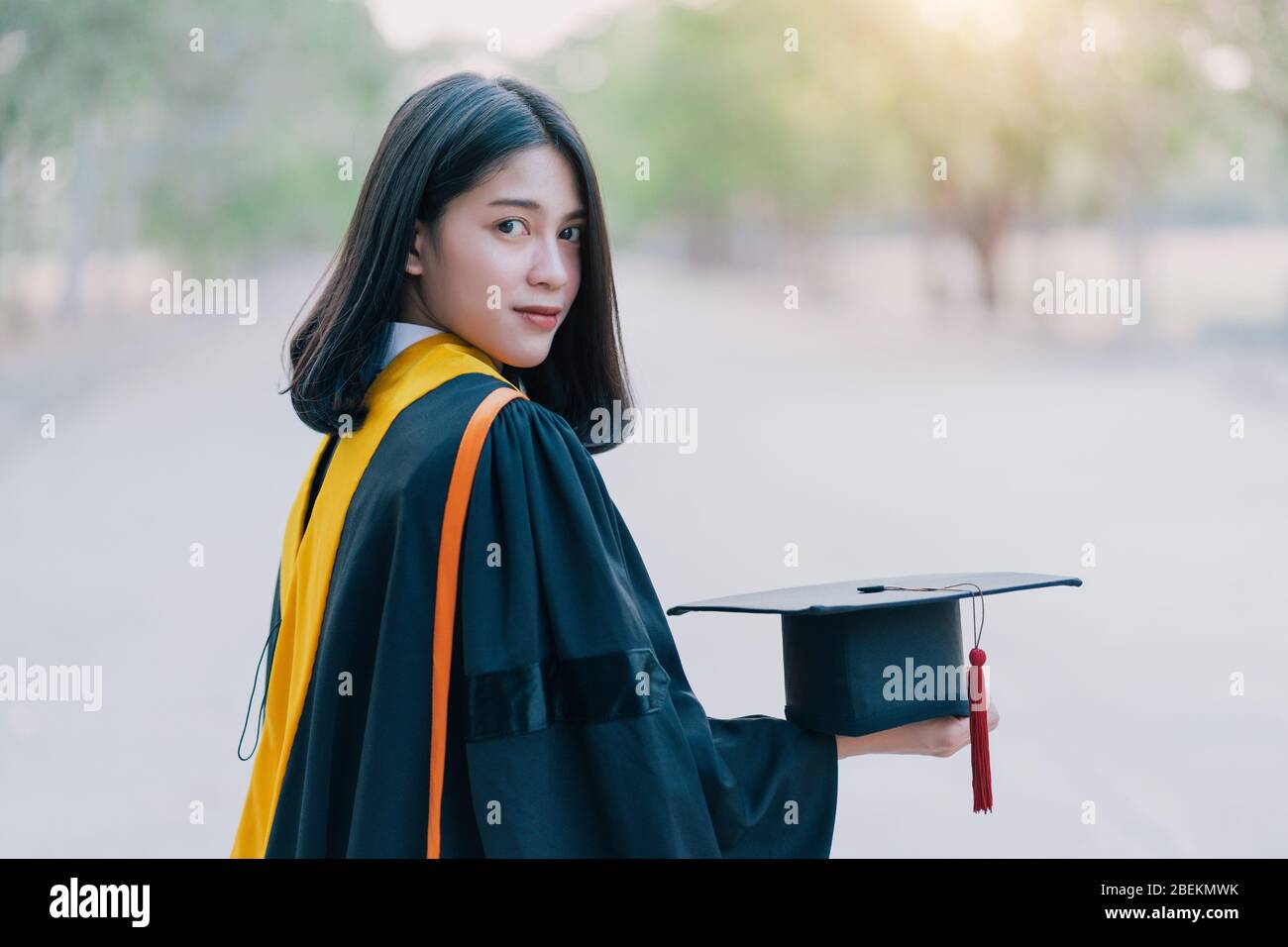 Young charming Asian female graduates celebrate her degree graduation ...