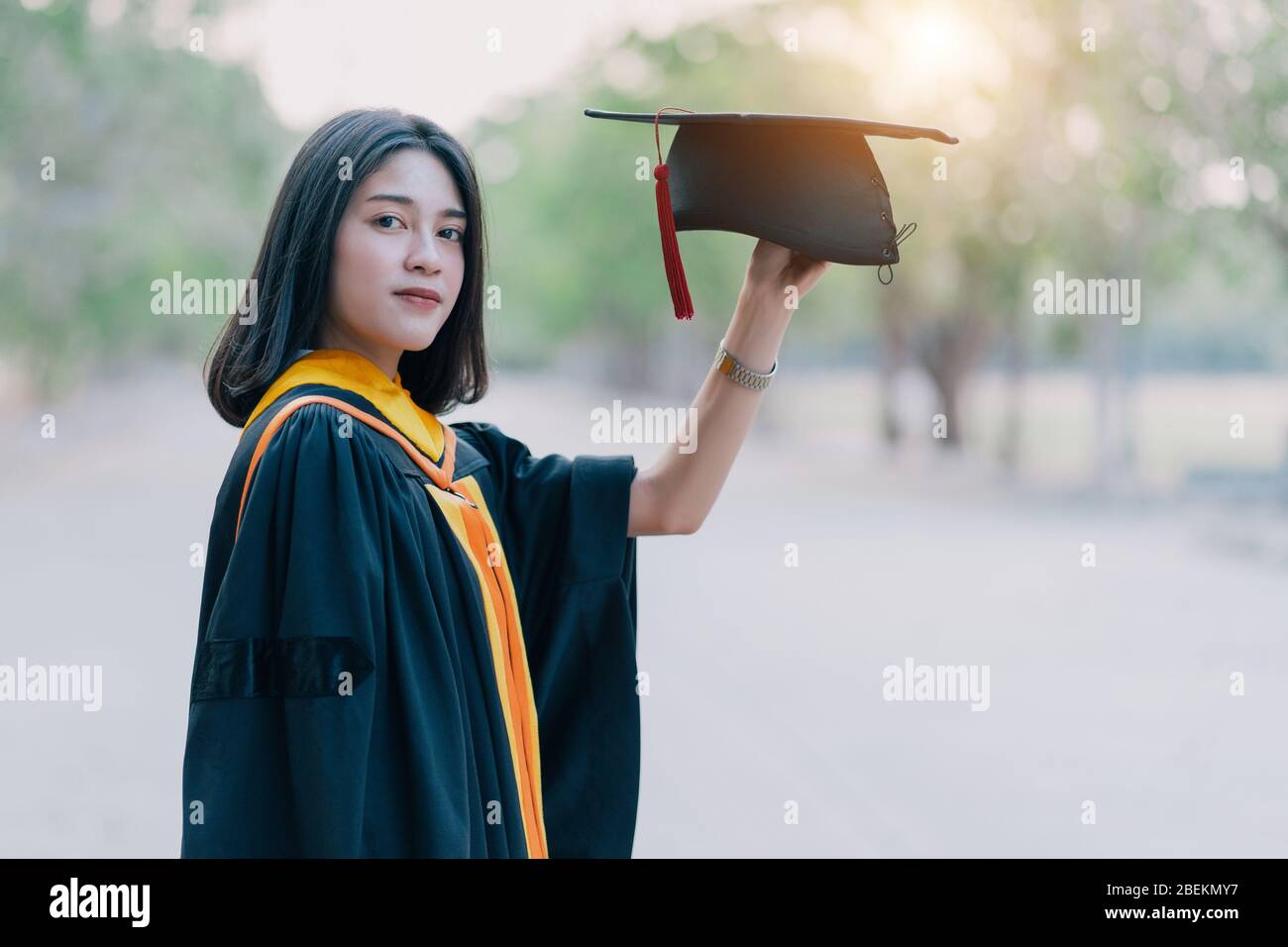 Young charming Asian female graduates celebrate her degree graduation ...