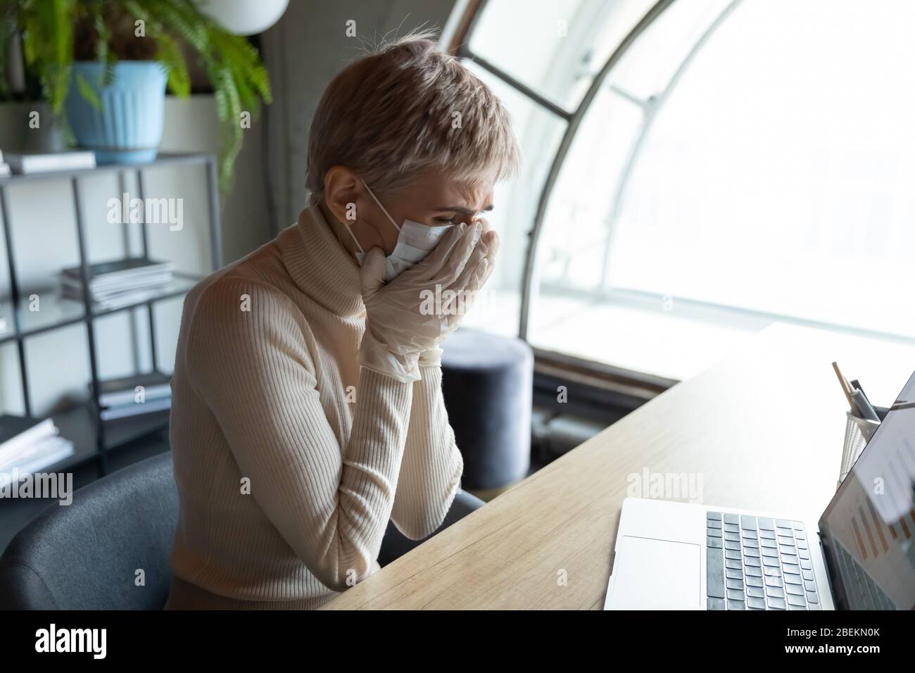 Sick female employee infected with covid-19 in office Stock Photo - Alamy