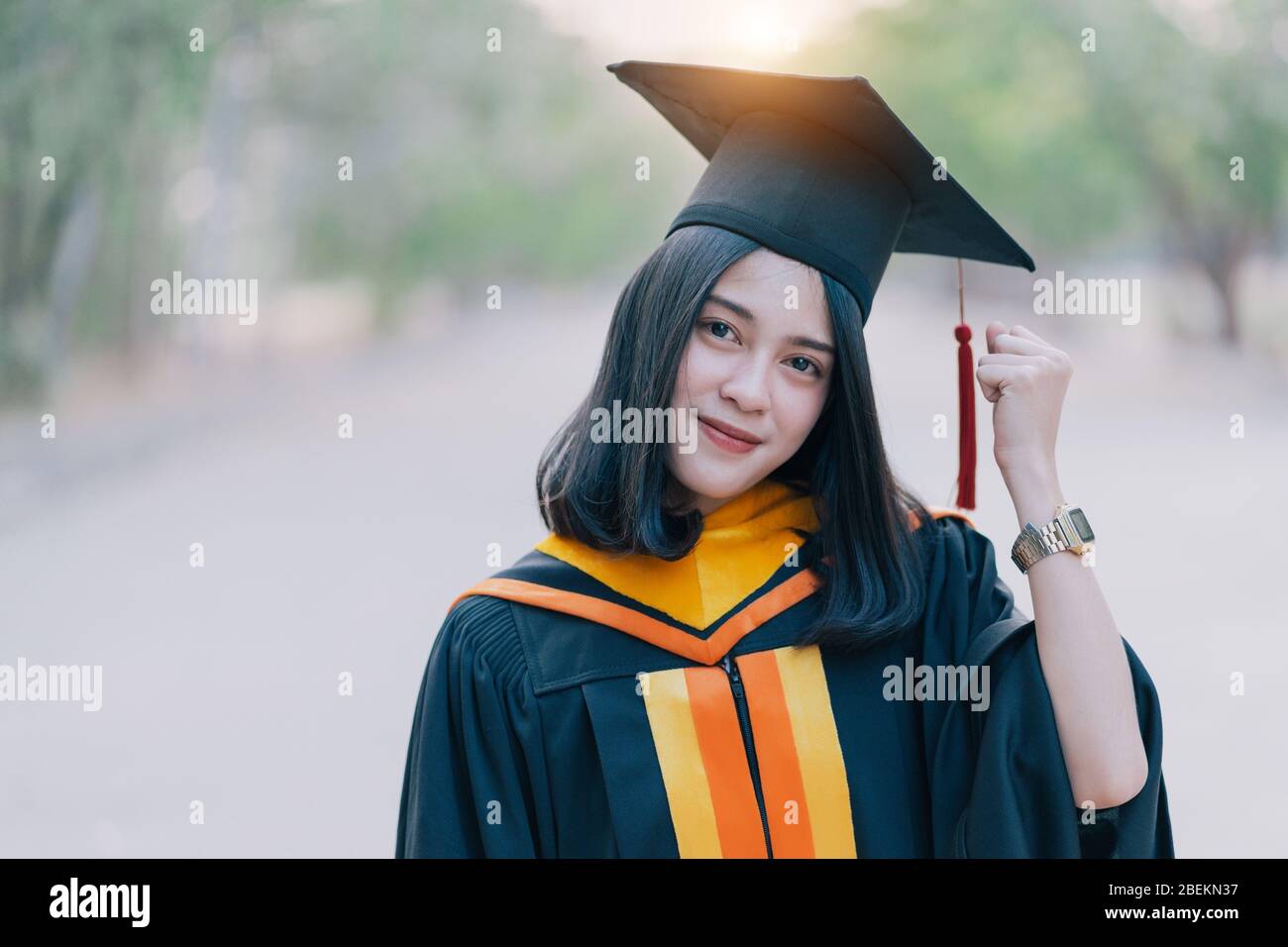 Young charming Asian female graduates celebrate her degree graduation ...