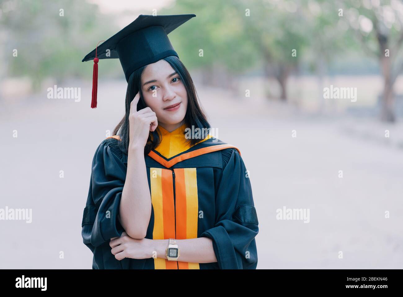 Young charming Asian female graduates celebrate her degree graduation ...