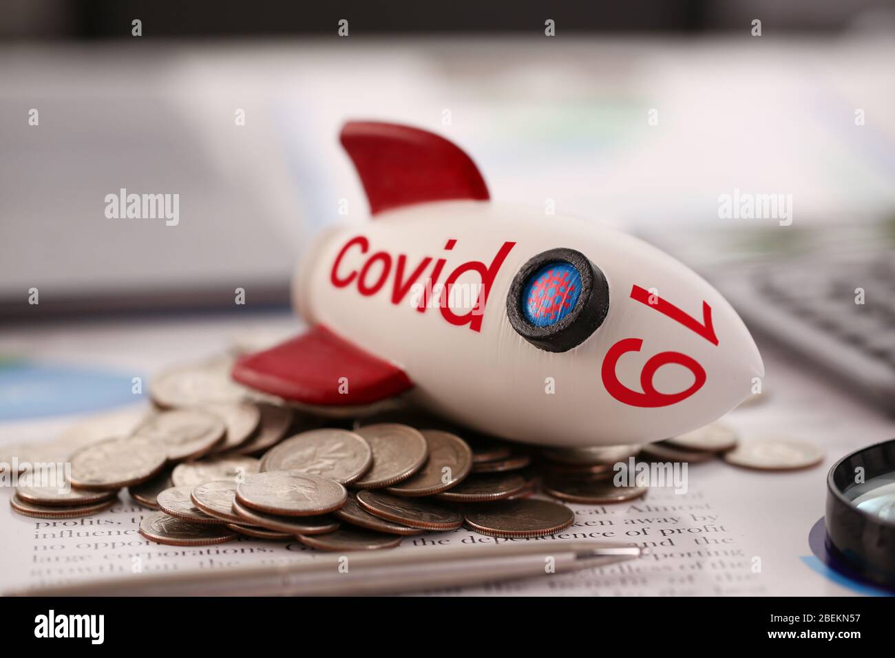 Rocket with inscription Covid 19 fell on a pile of coins Stock Photo ...