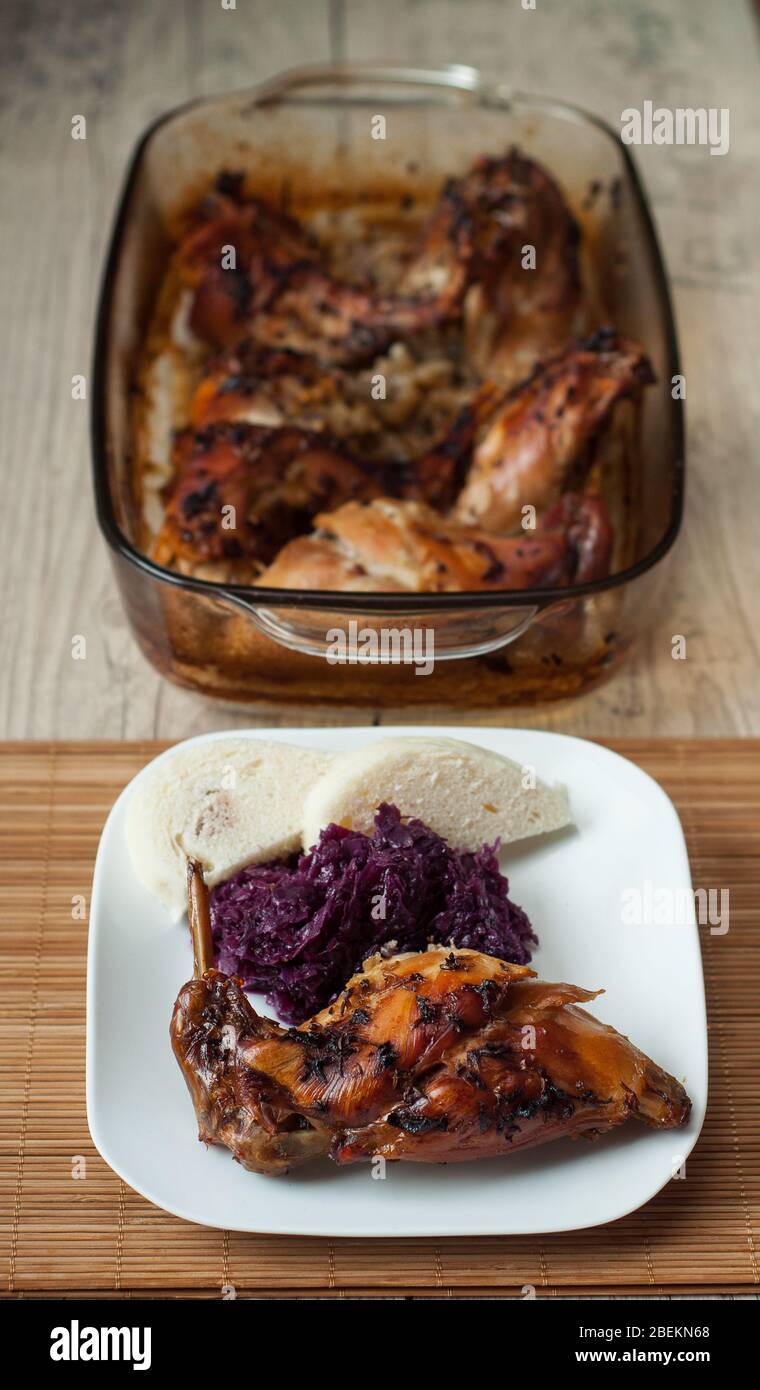 rabbit meat roaster with onion cumin and garlic on wooden vintage table ...