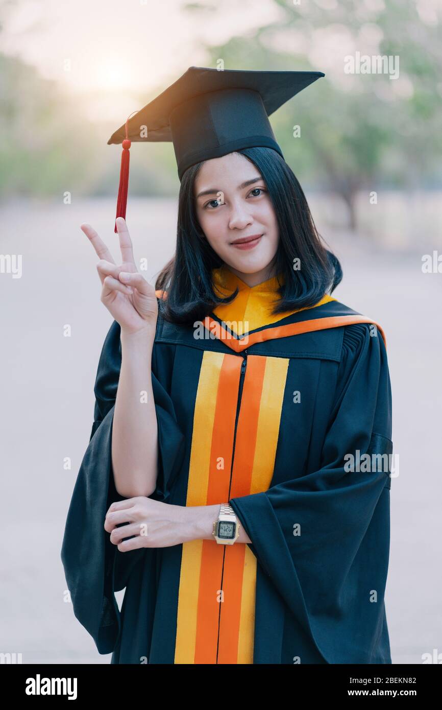 Young charming Asian female graduates celebrate her degree graduation ...