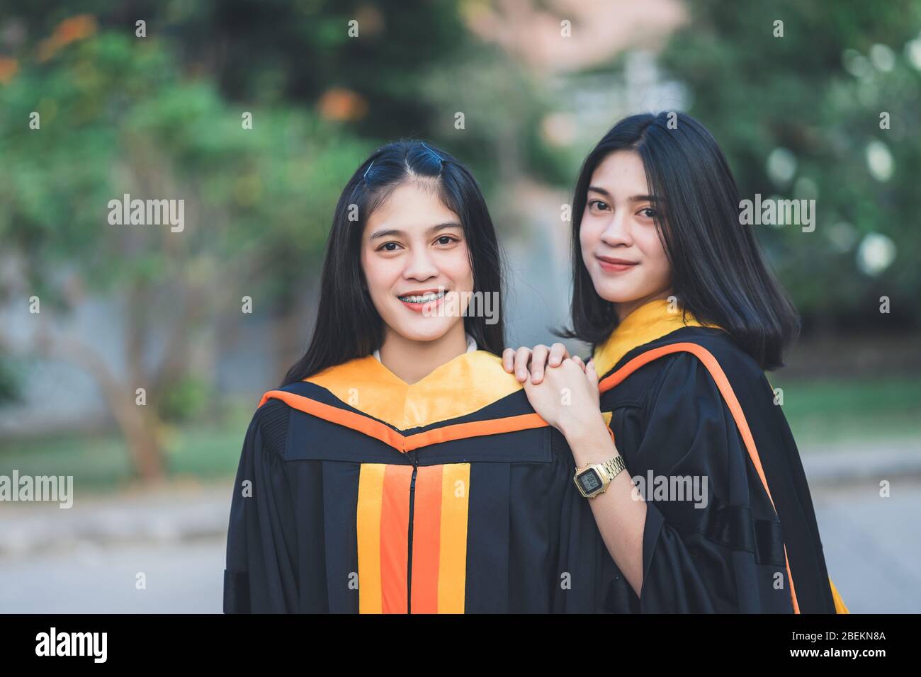 Young charming Asian female graduates celebrate her degree graduation ...