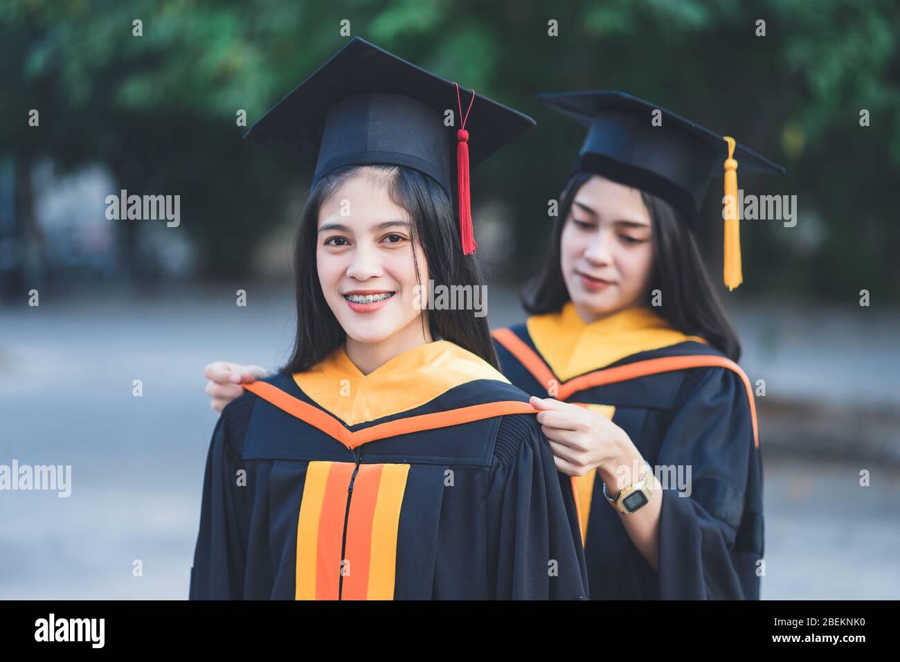 Young charming Asian female graduates celebrate her degree graduation ...