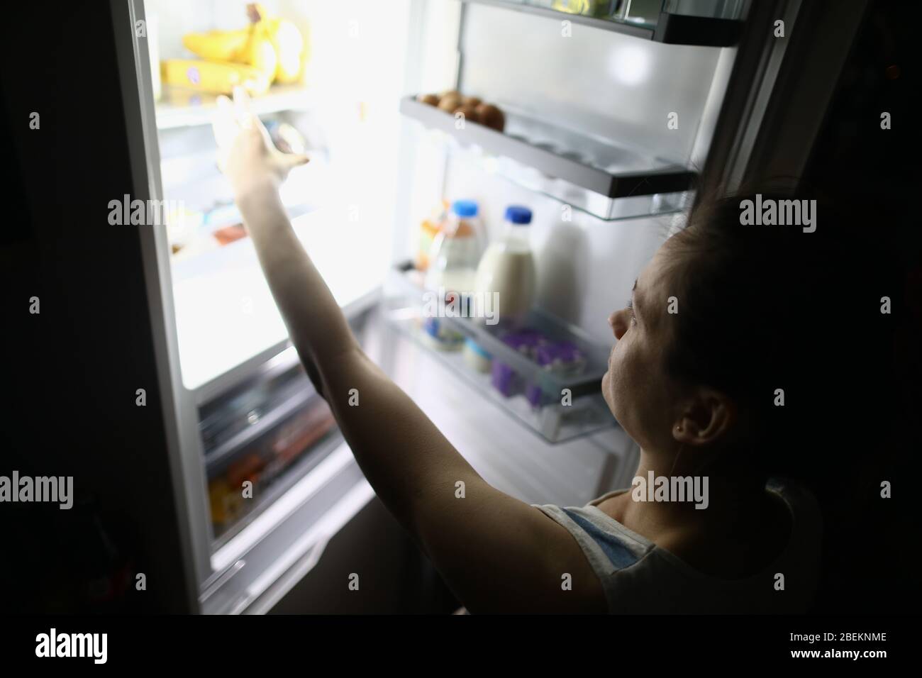 Young woman standing open refrigerator hi-res stock photography and ...
