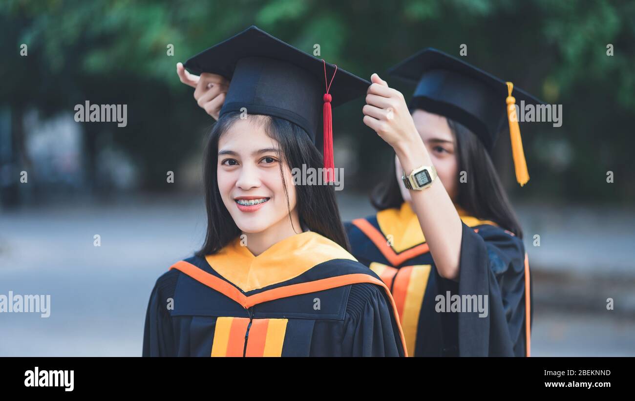 Young charming Asian female graduates celebrate her degree graduation ...