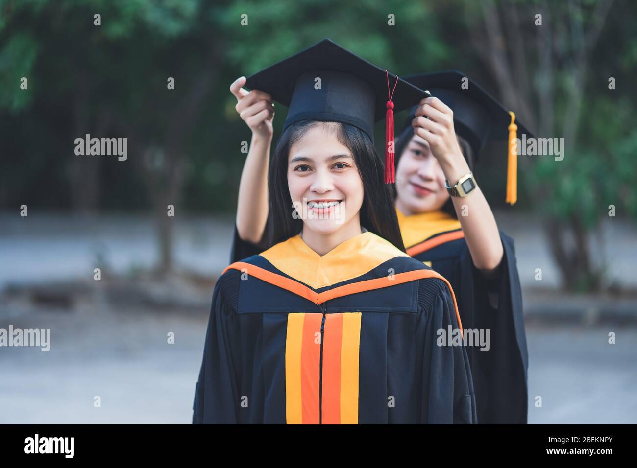 Young charming Asian female graduates celebrate her degree graduation ...