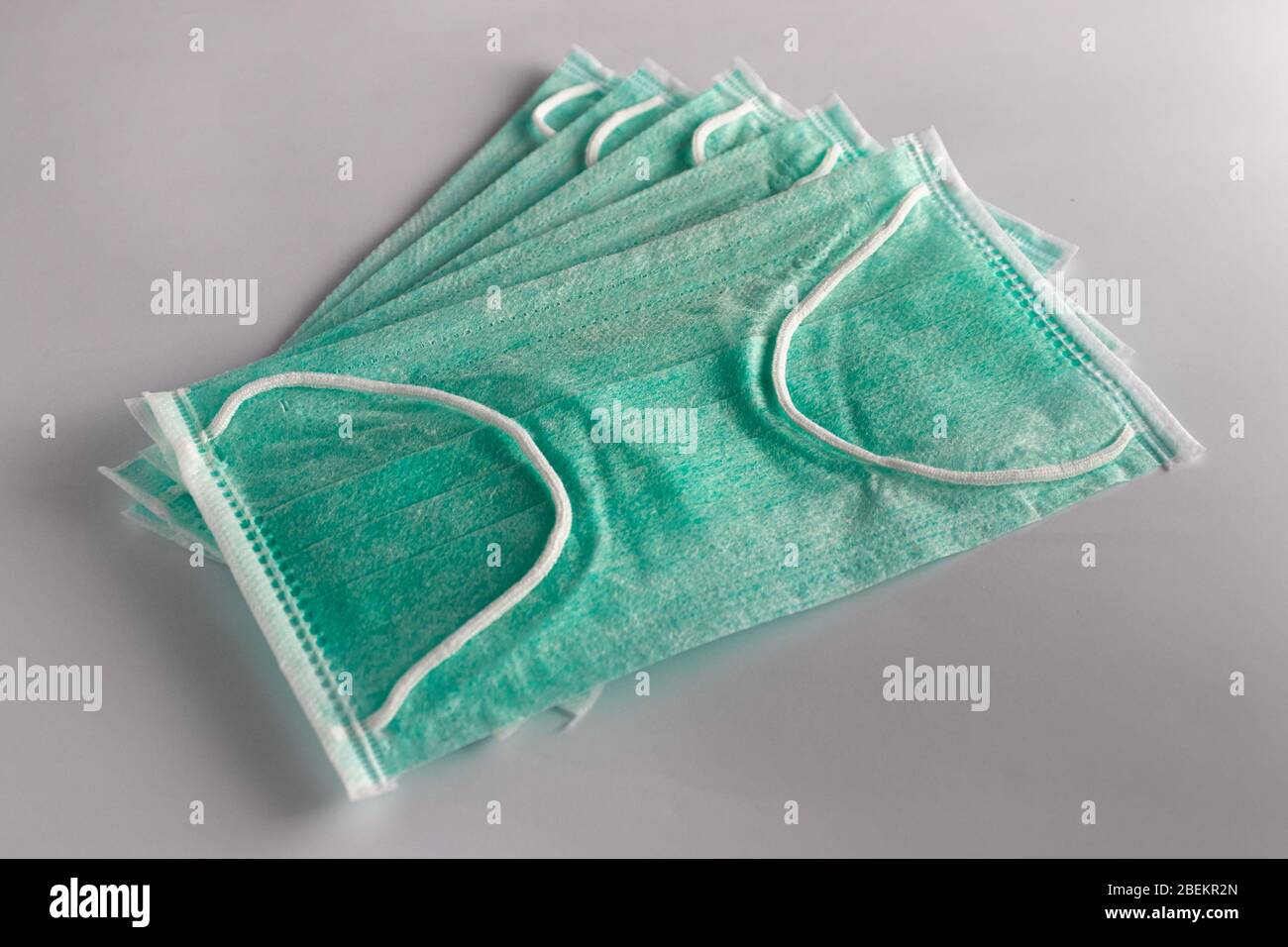 a stack of green surgical masks on a white background Stock Photo - Alamy