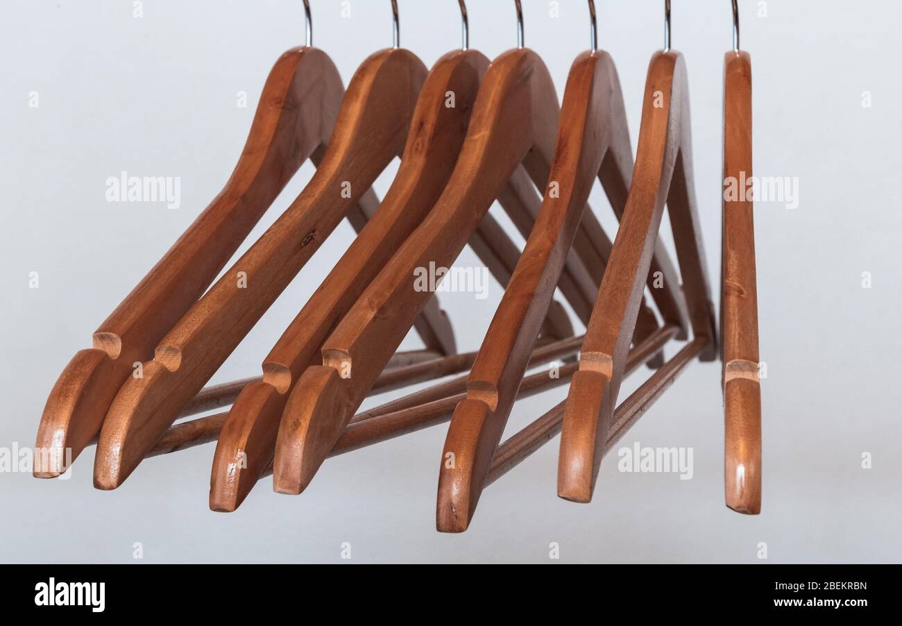 wooden empty hangers for clothes on white background Stock Photo - Alamy