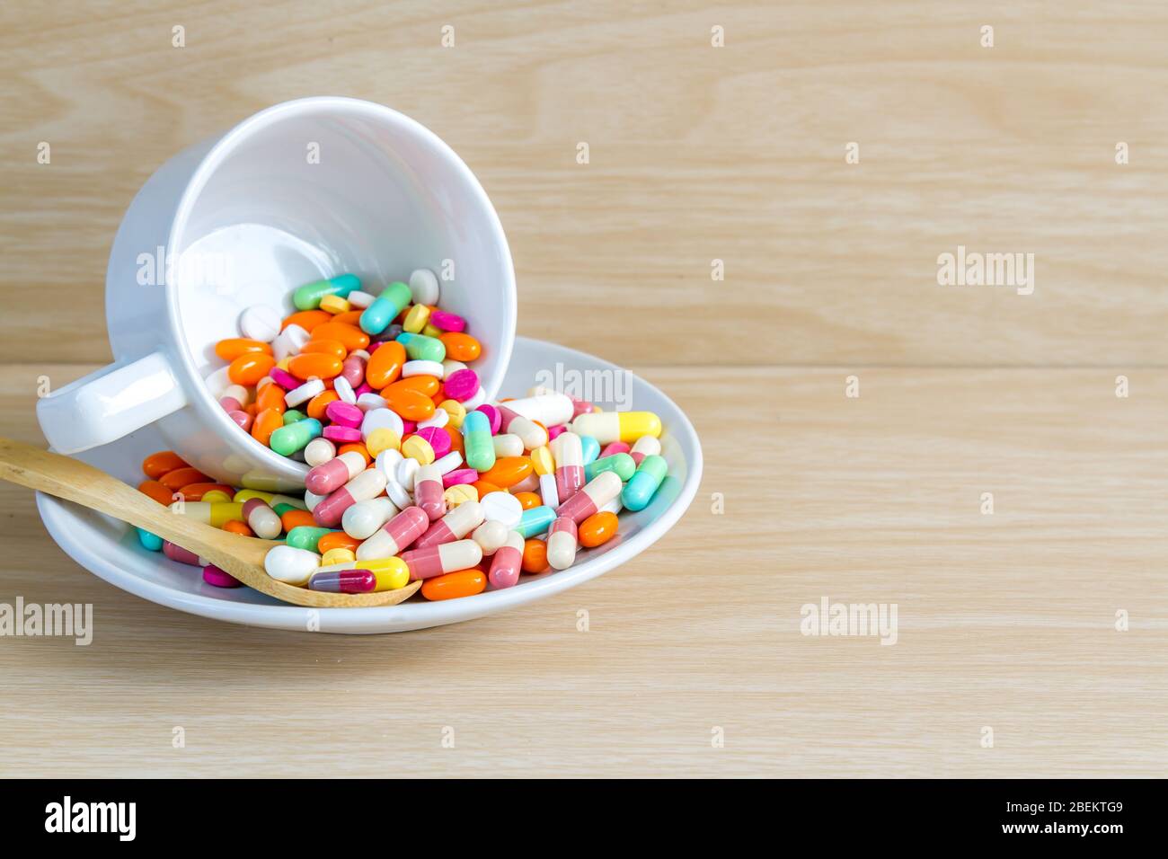 Medicine is pill and capsule in coffee cup with copy space on wood ...