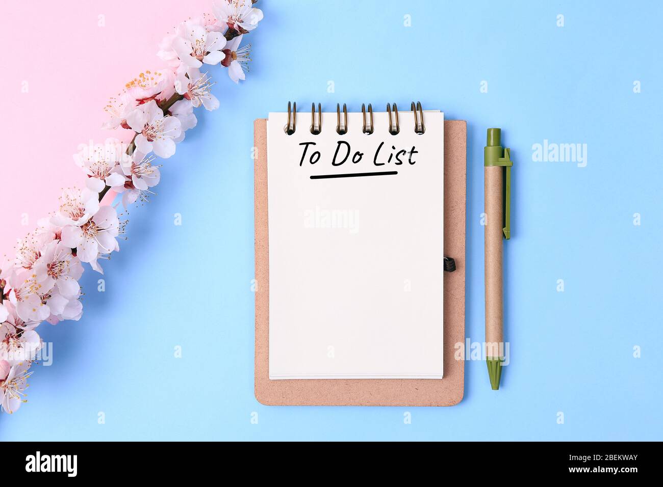 A small notebook with a to do list and a pen on beautiful spring ...