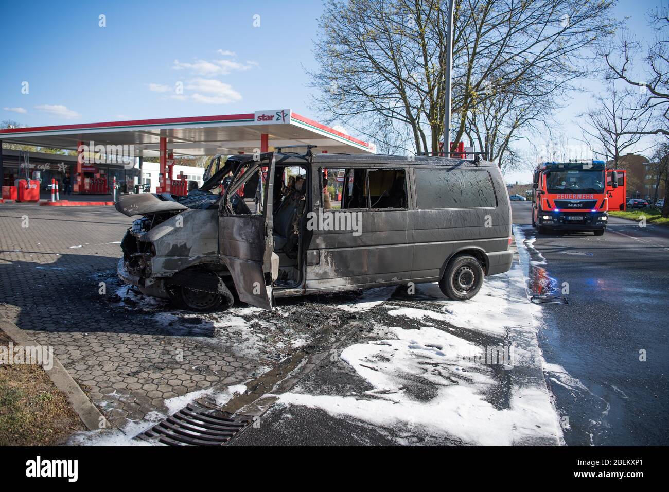 14 April 2020, Berlin: A completely burnt-out VW bus is standing at a ...