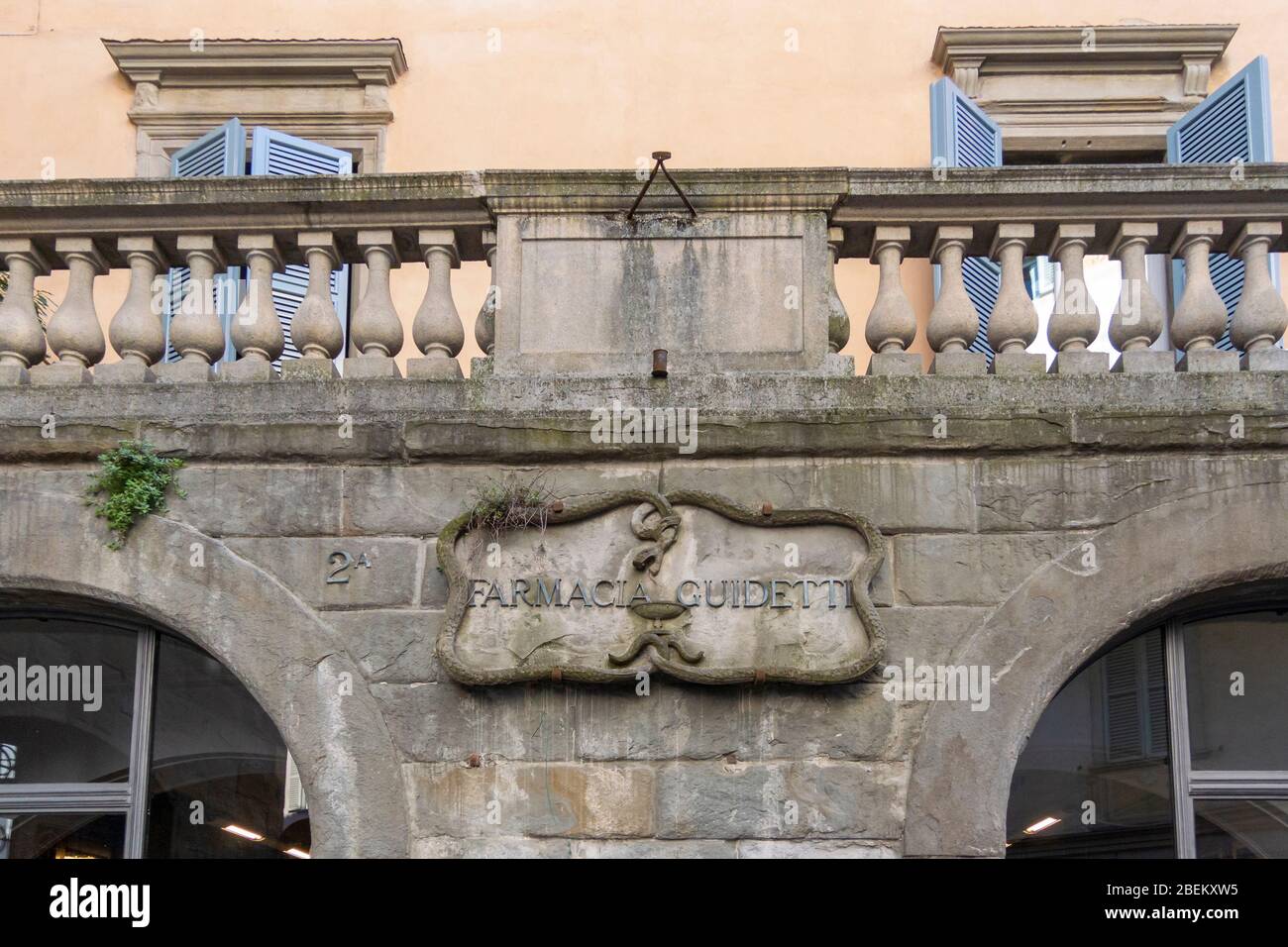 An ancient pharmacy sign on a building wall in the old city of Bergamo ...