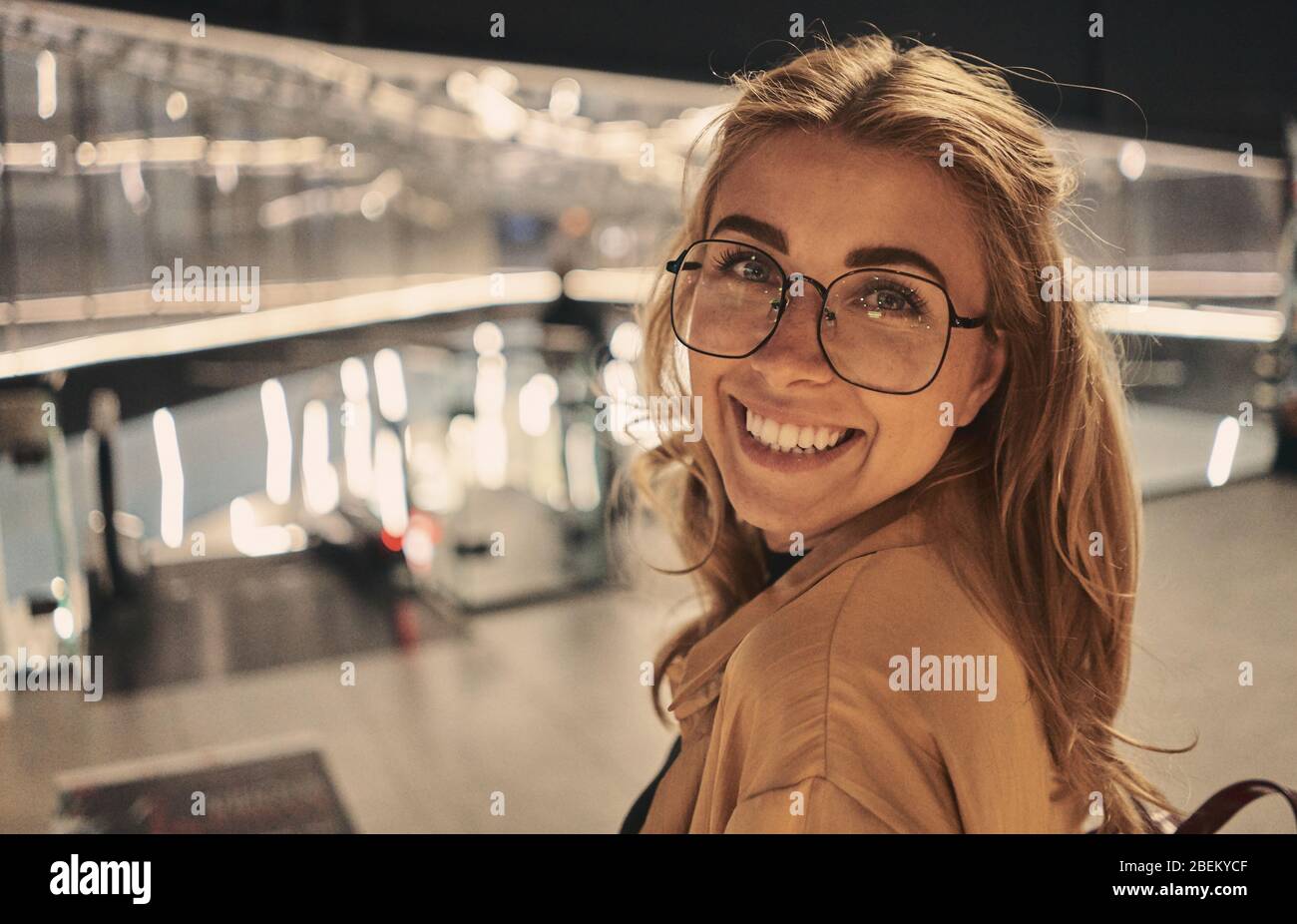Beautiful blonde young woman in the shopping mall Stock Photo - Alamy