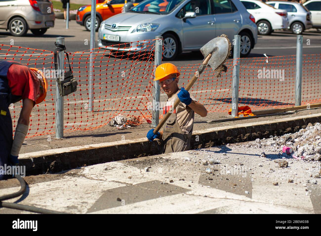 Repair work on the city street. Professional workers dismantle part of ...