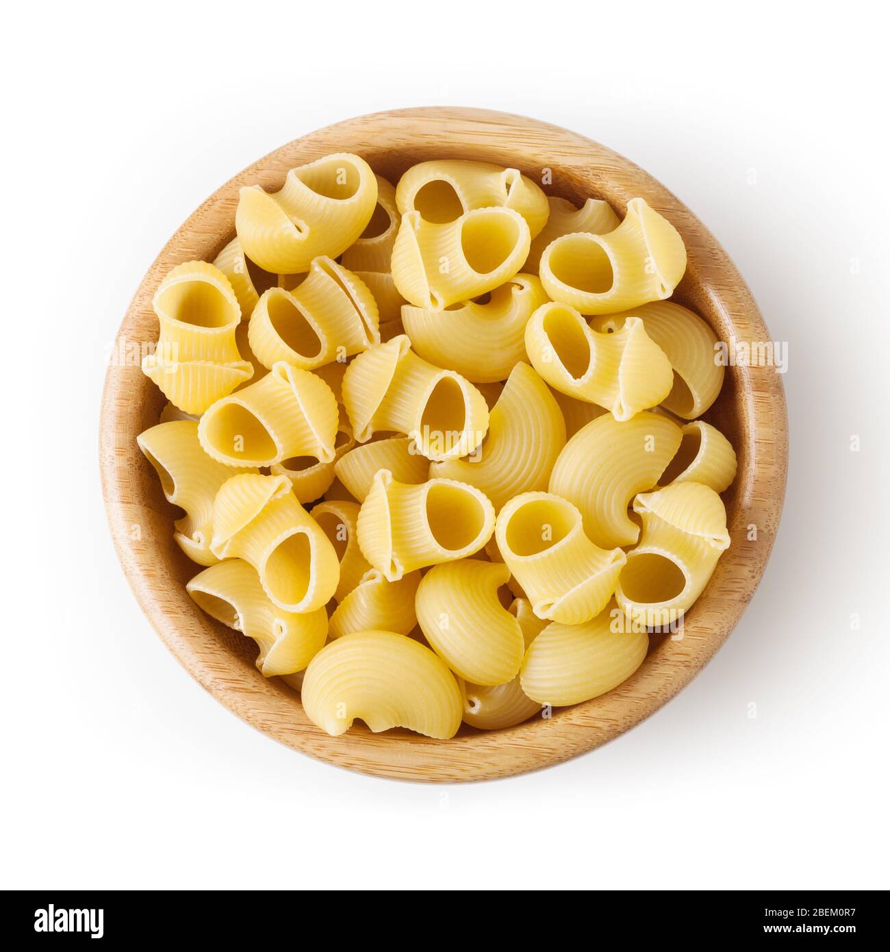 Uncooked pipe rigate pasta in wooden bowl isolated on white background ...