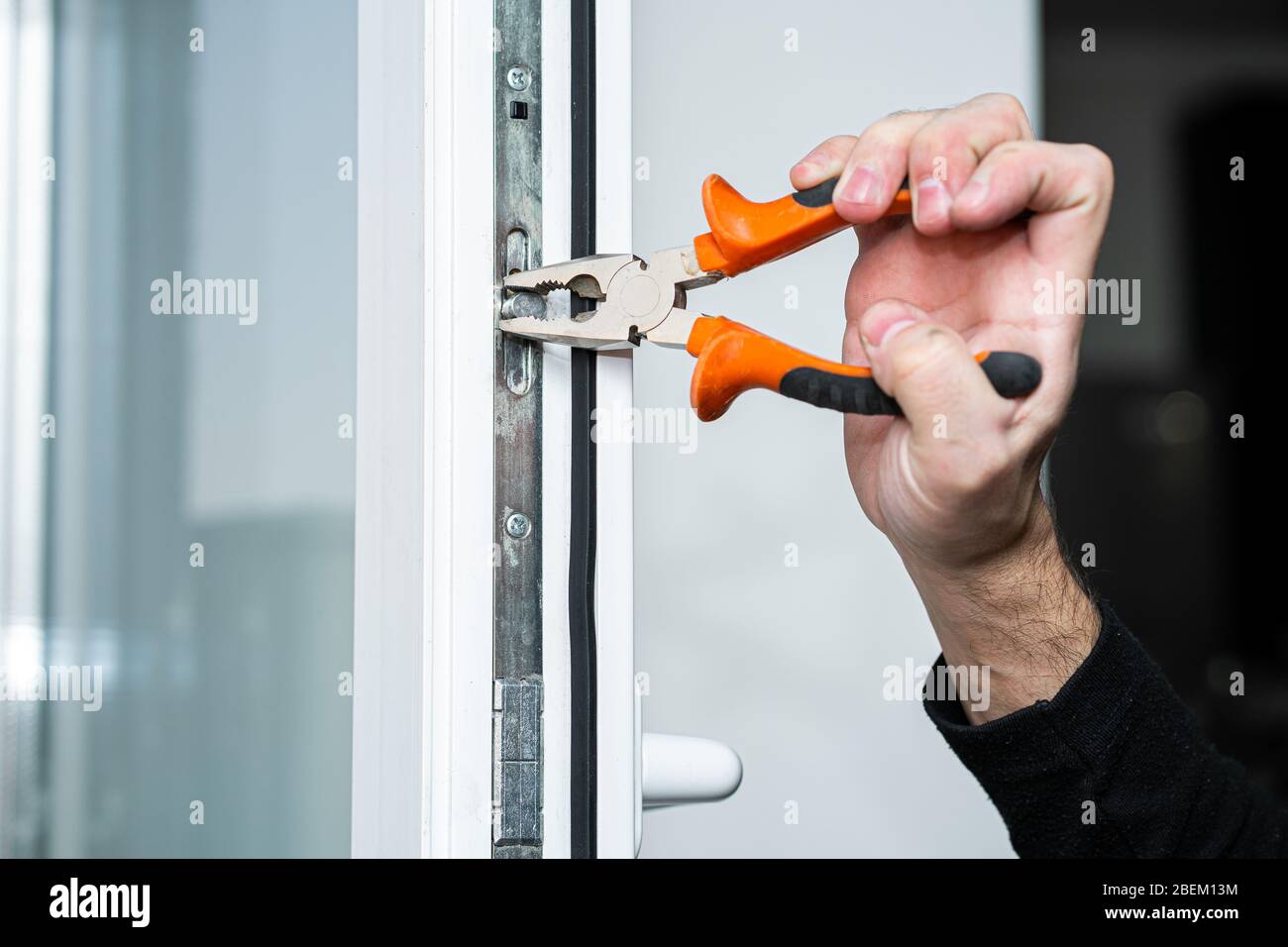 Professional master for repair and installation of windows, sets up a ...