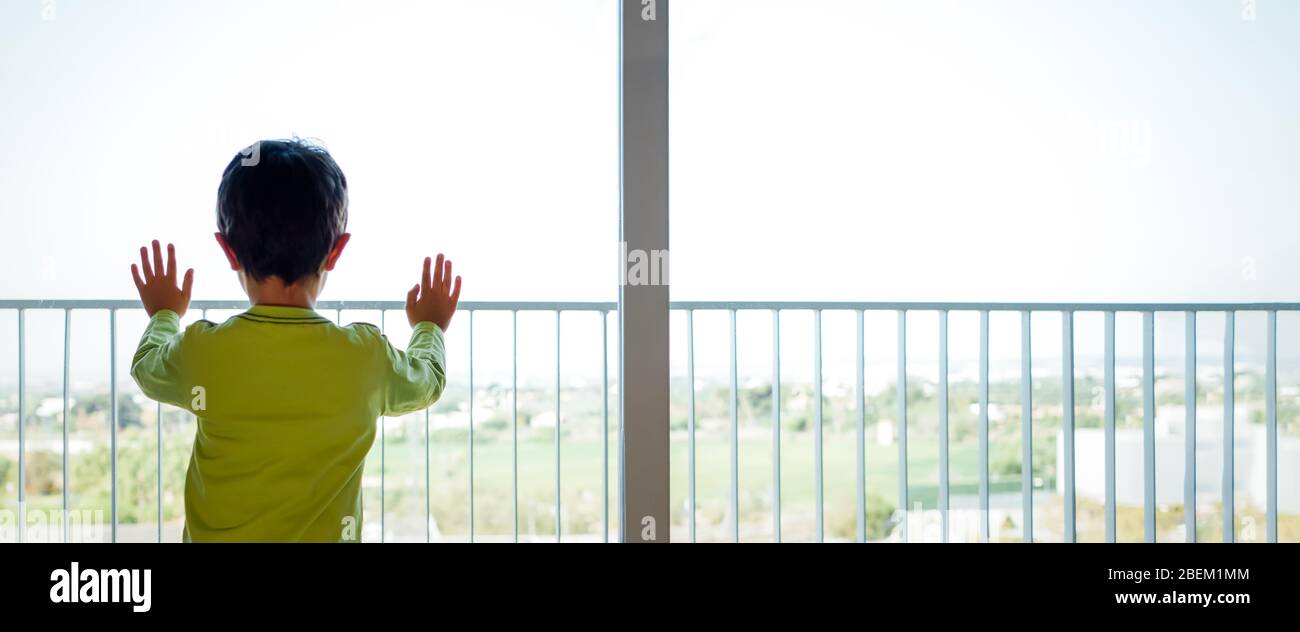 Child looking outside through the window with hope Stock Photo - Alamy
