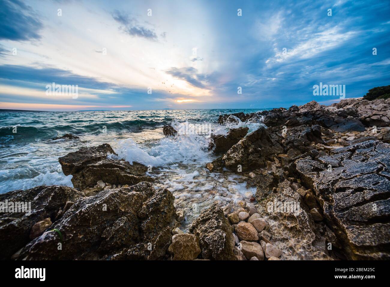 sunset on croatian stony beach Stock Photo - Alamy