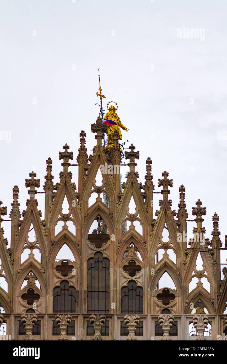 Golden Madonna statue and spires on the rooftop of the gothic Cathedral ...