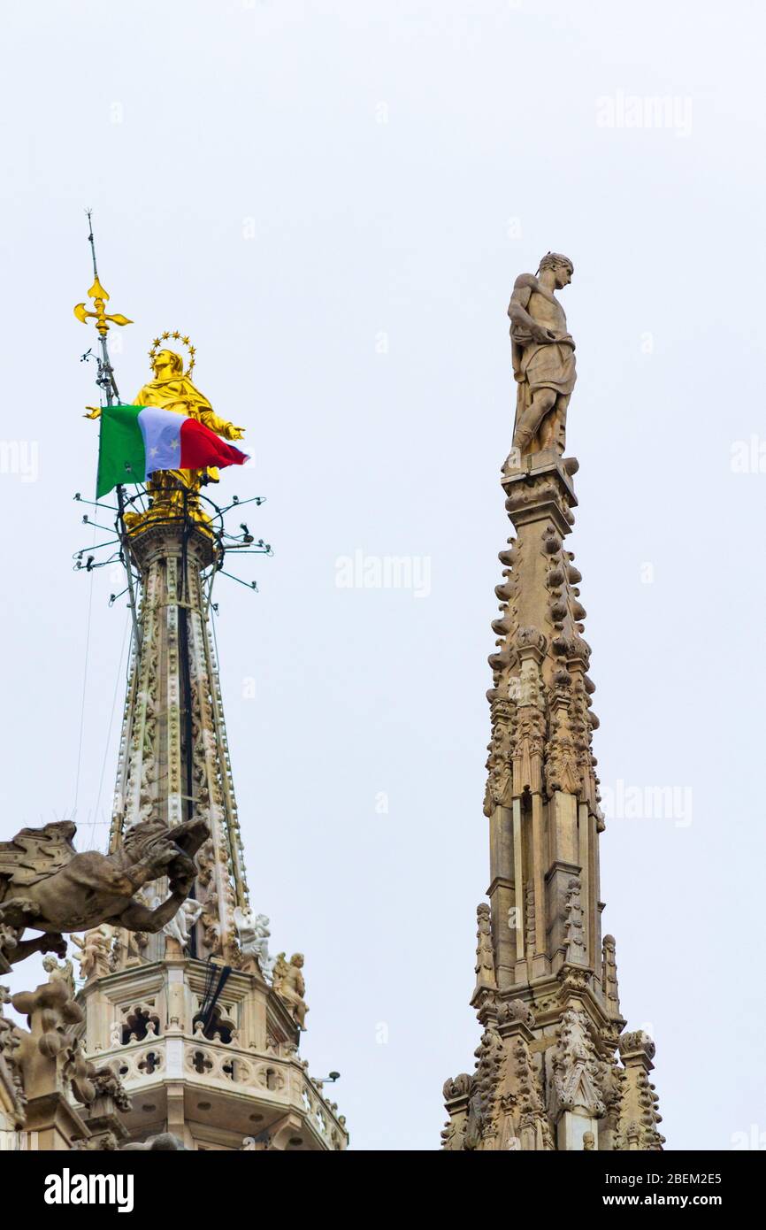 Golden Madonna statue and spires on the rooftop of the gothic Cathedral ...