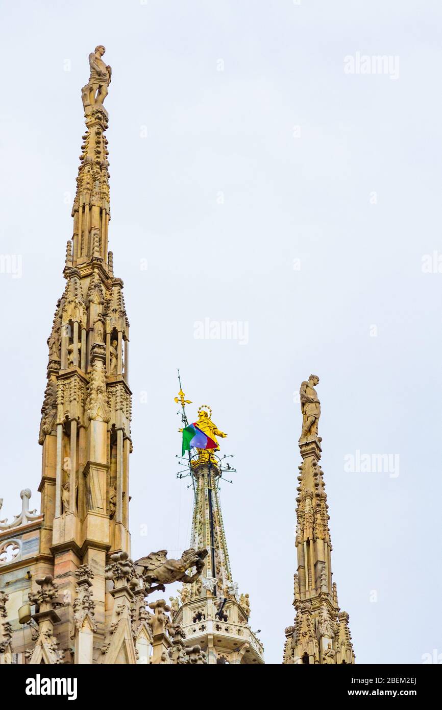 Golden Madonna statue and spires on the rooftop of the gothic Cathedral ...
