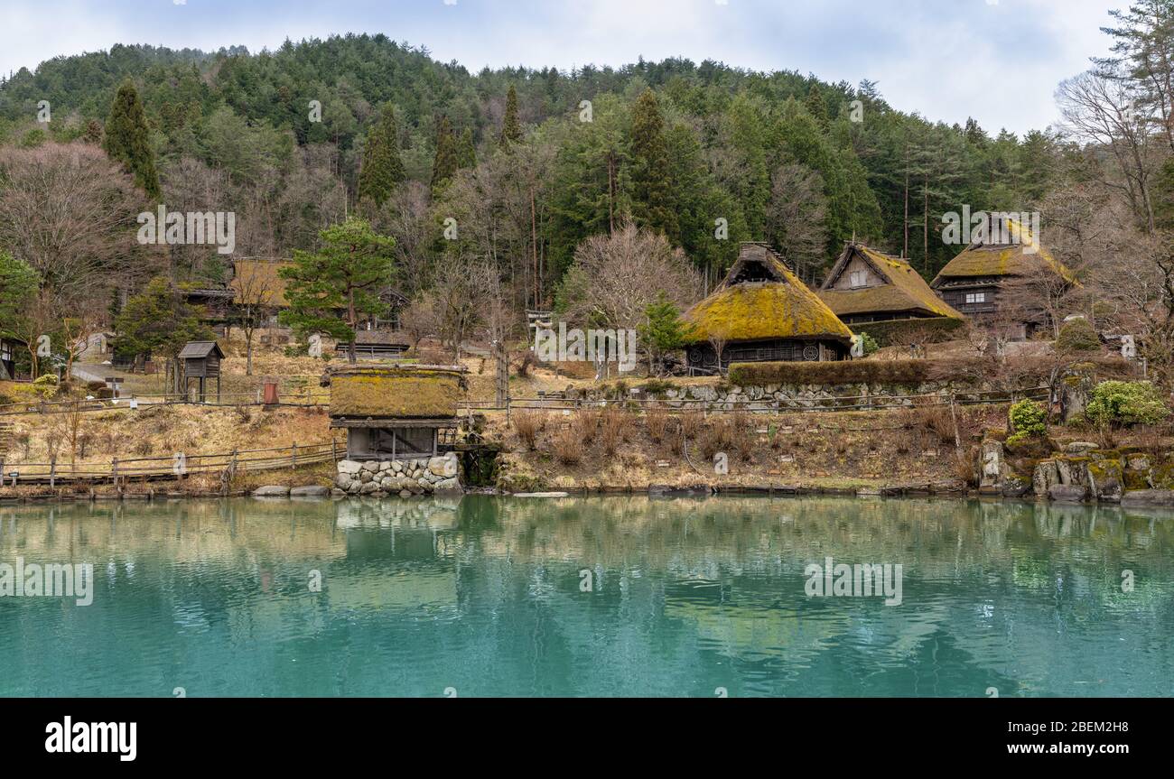 Pond and Hida Folk Village (Hida no Sato) with traditional HIda region ...