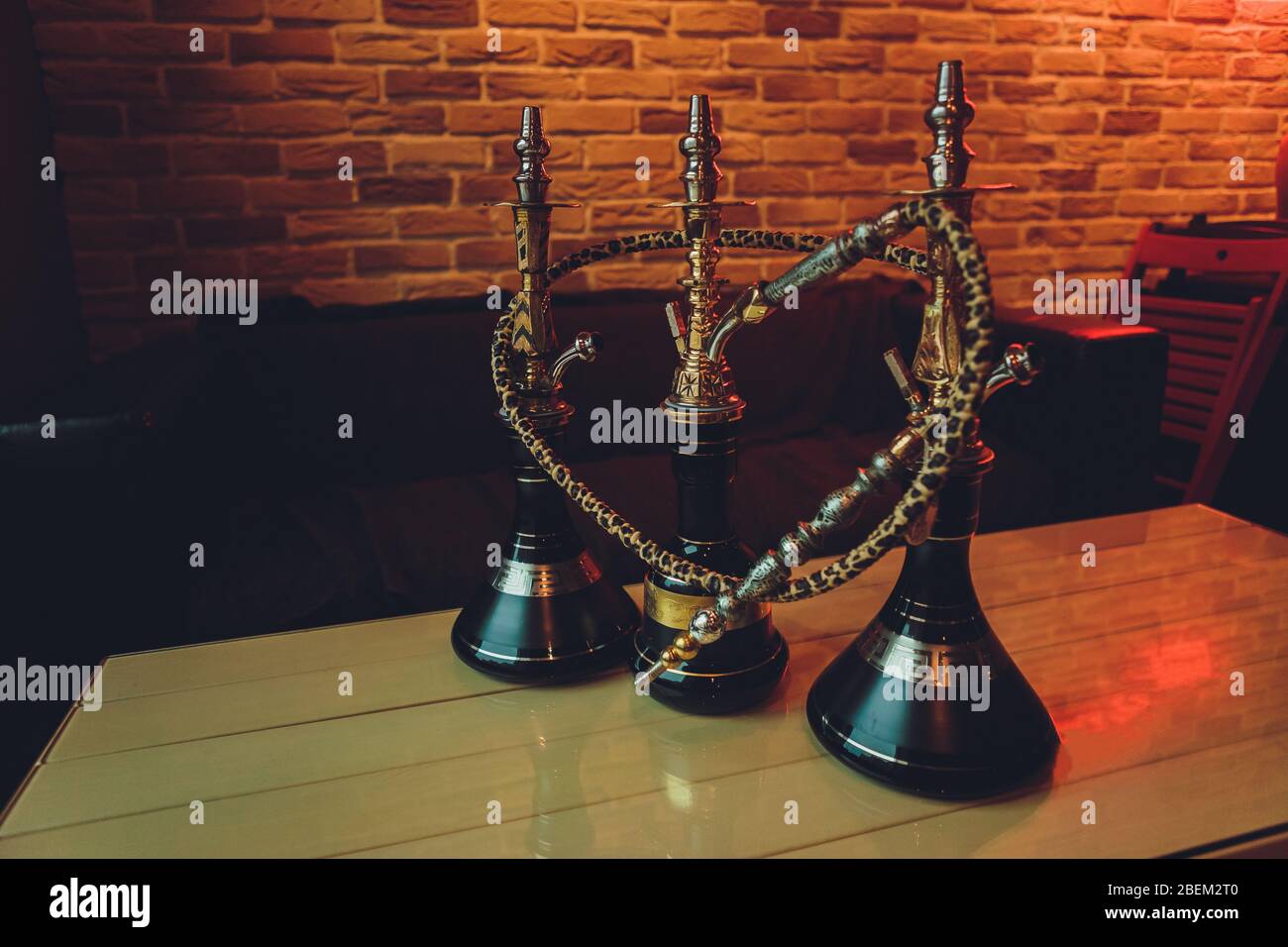 Stylish wooden hookah in the evening on a summer terrace in a cafe ...
