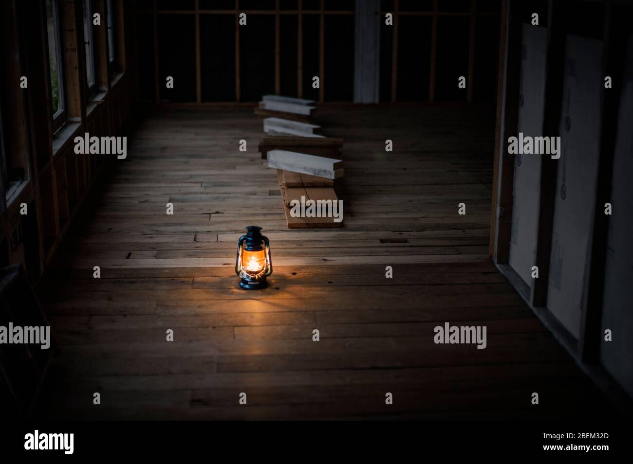 Oil lantern illuminating a cabin under construction Stock Photo - Alamy