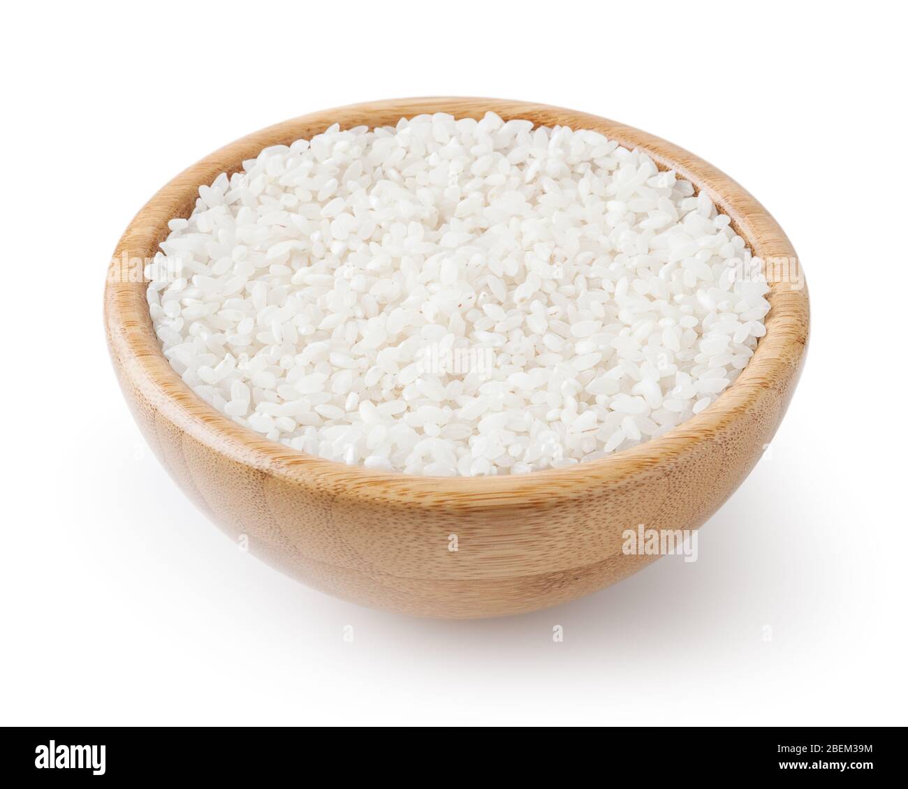 Uncooked round rice in wooden bowl isolated on white background with ...