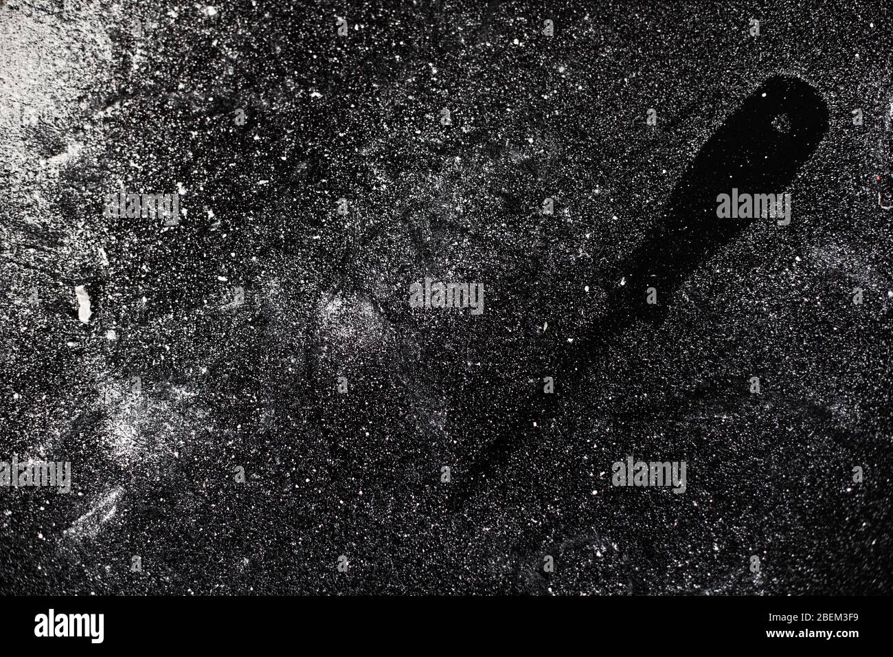 Traces of tools on a black table dusted with white dust Stock Photo - Alamy