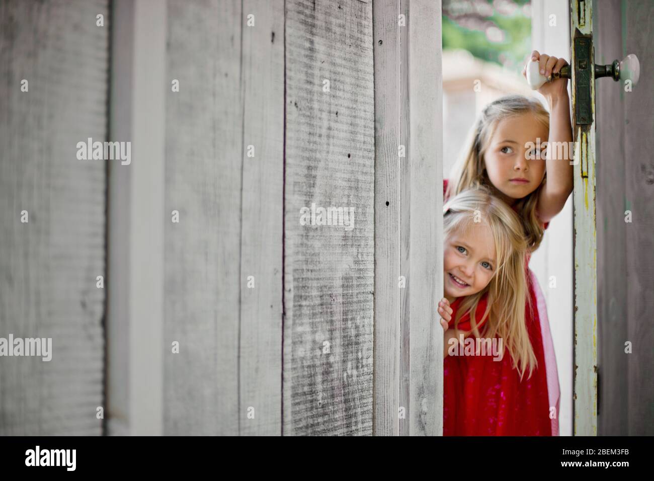 Child peering through door hi-res stock photography and images - Alamy