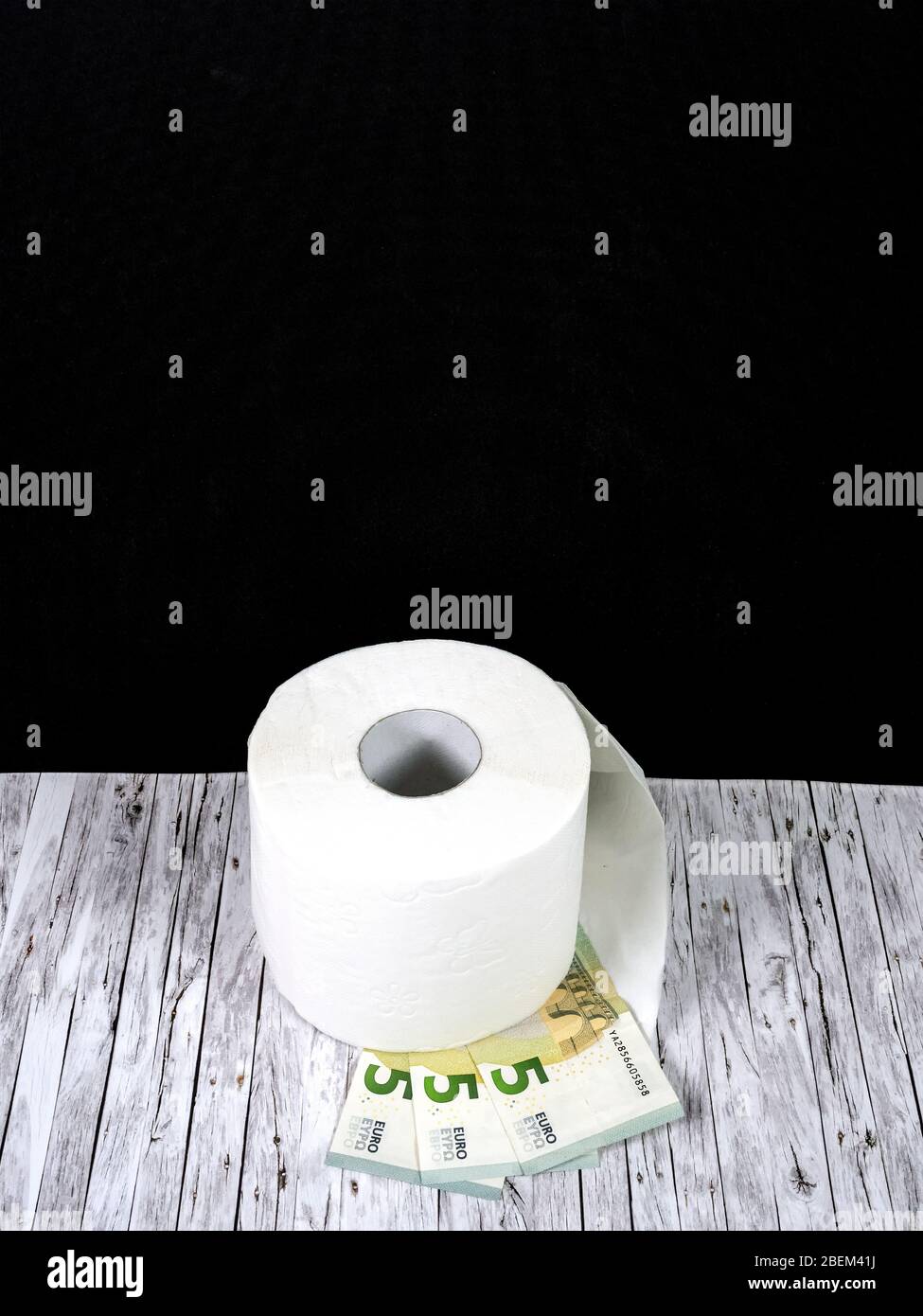 One roll of white toilet paper and three five euro notes Stock Photo ...