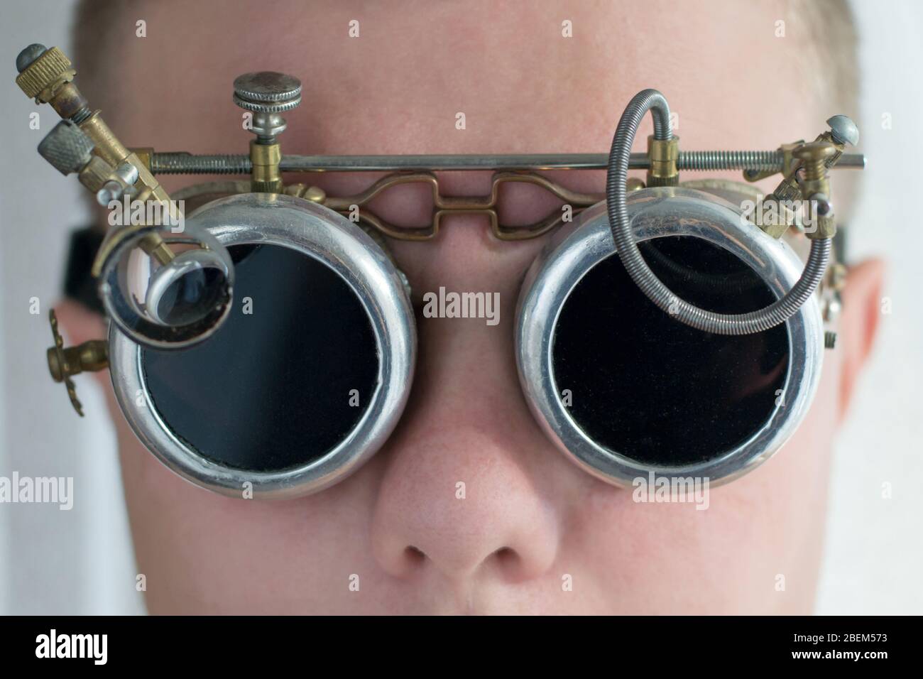 A man in metal goggles, steampunk style, close up Stock Photo - Alamy