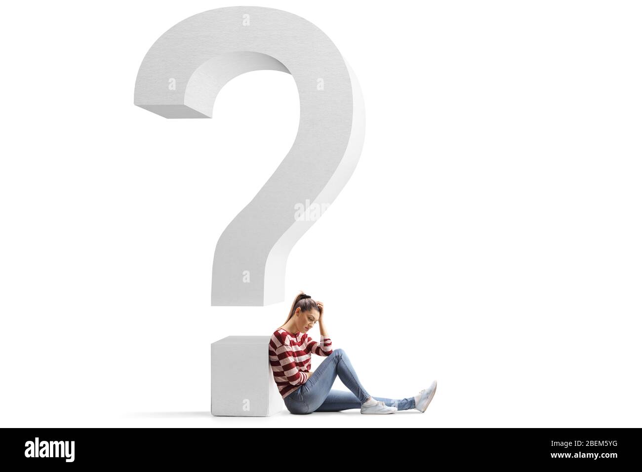Sad young woman sitting on the floor and leaning on a big question mark ...