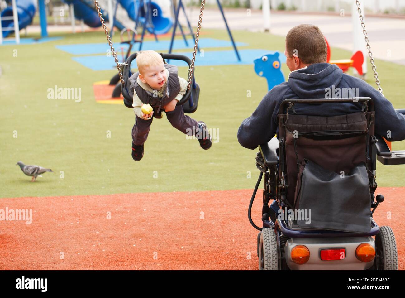 Disabled Father play with his little son on the playground Stock Photo ...