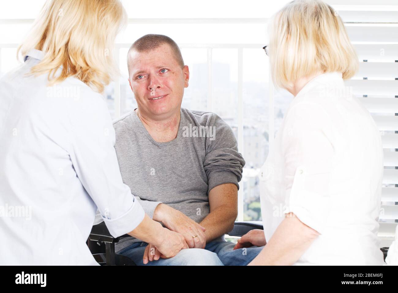 Two female doctors consoling a crying patient Stock Photo - Alamy