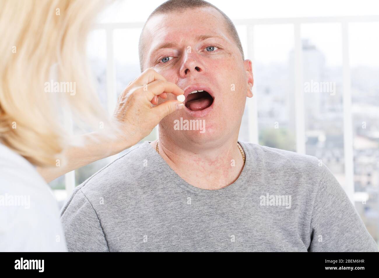 Hand of nurse giving patient medication Stock Photo - Alamy