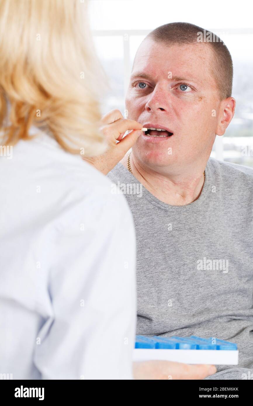 Hand of nurse giving patient medication Stock Photo - Alamy