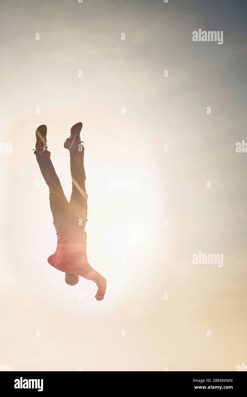 Man falling down from the sky in straight position. Man jumping upside ...